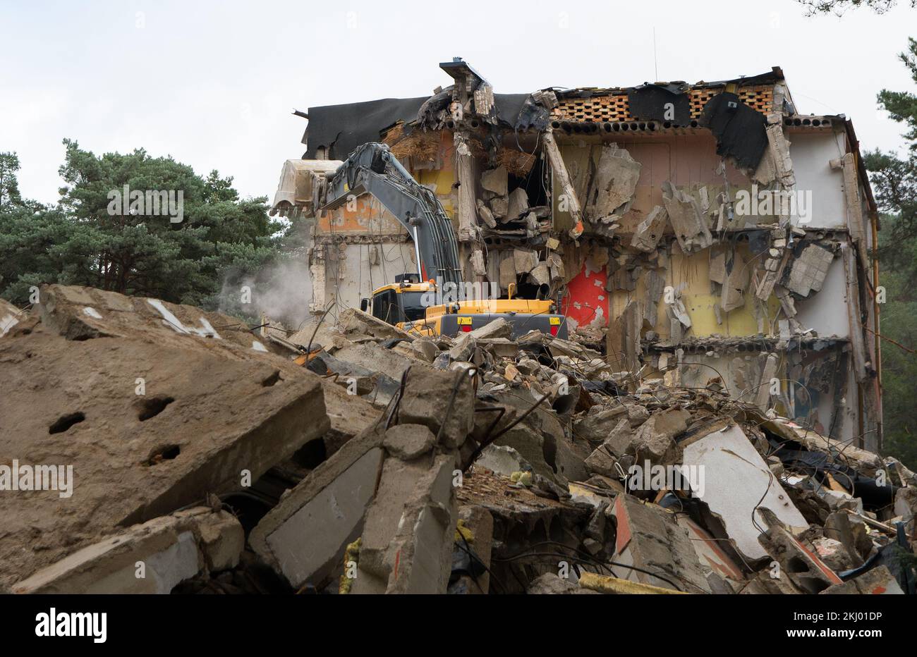 Process of demolition of old building dismantling. Excavator breaking ...