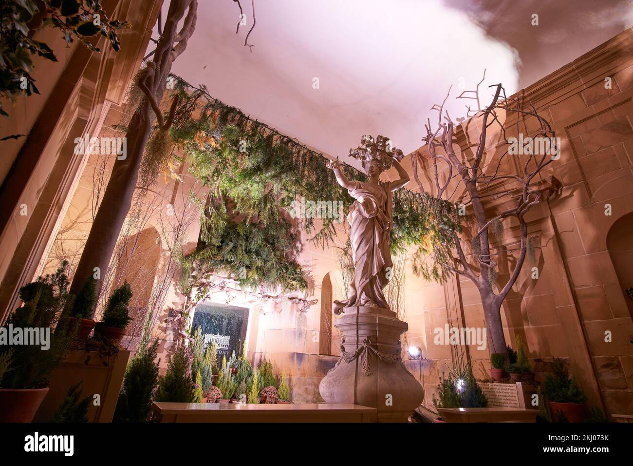 Classical garden statue lit up at night Stock Photo - Alamy