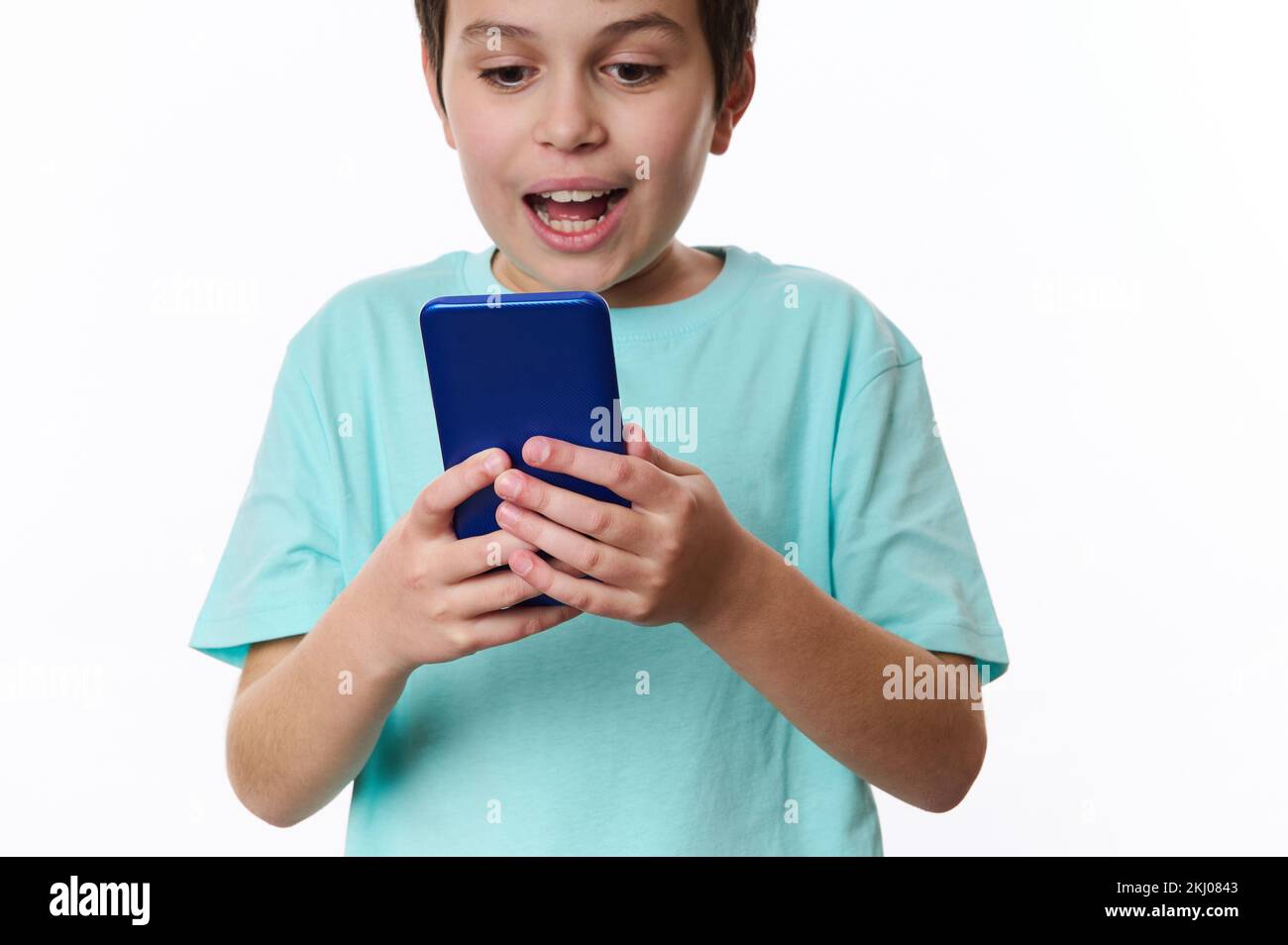 Selective focus on mobile phone in the hands of a cute child boy ...