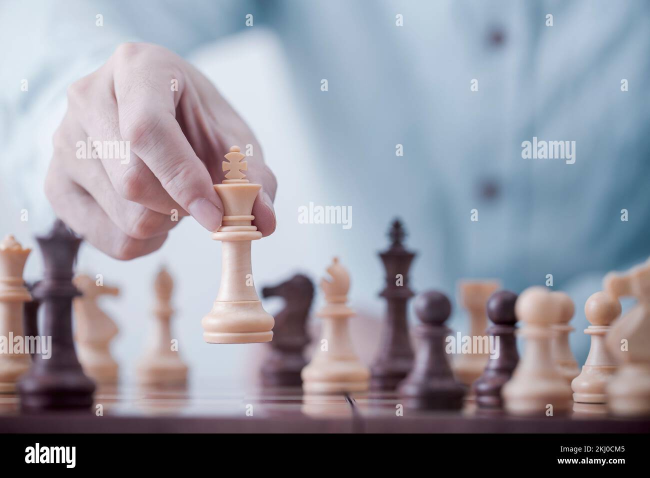 Businessman play with chess game in competition success play, concept ...