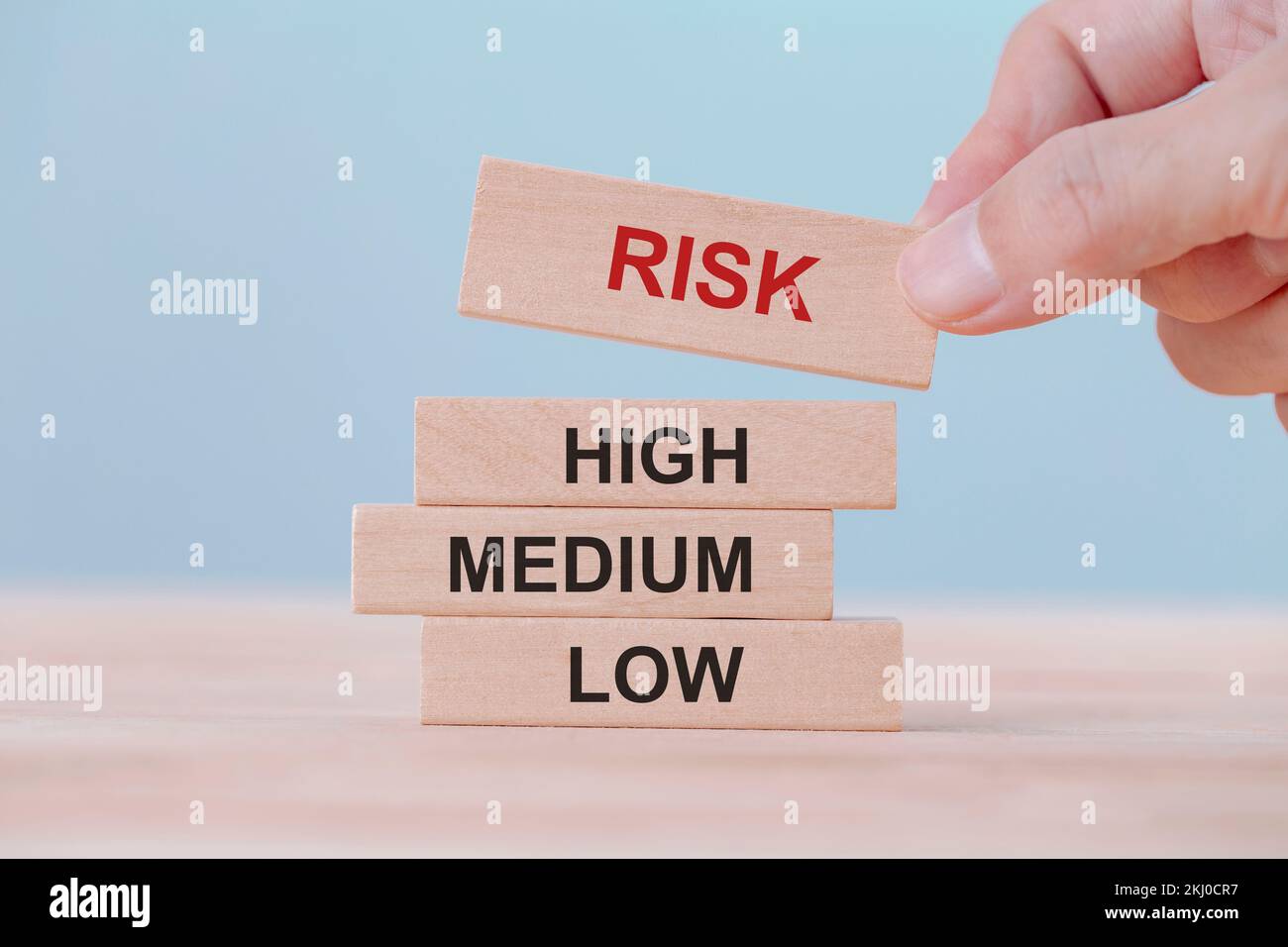 Hand holding chooses wooden block cubes with risk word. Risk management ... Hand holding chooses wooden block cubes with risk word. Risk management ...