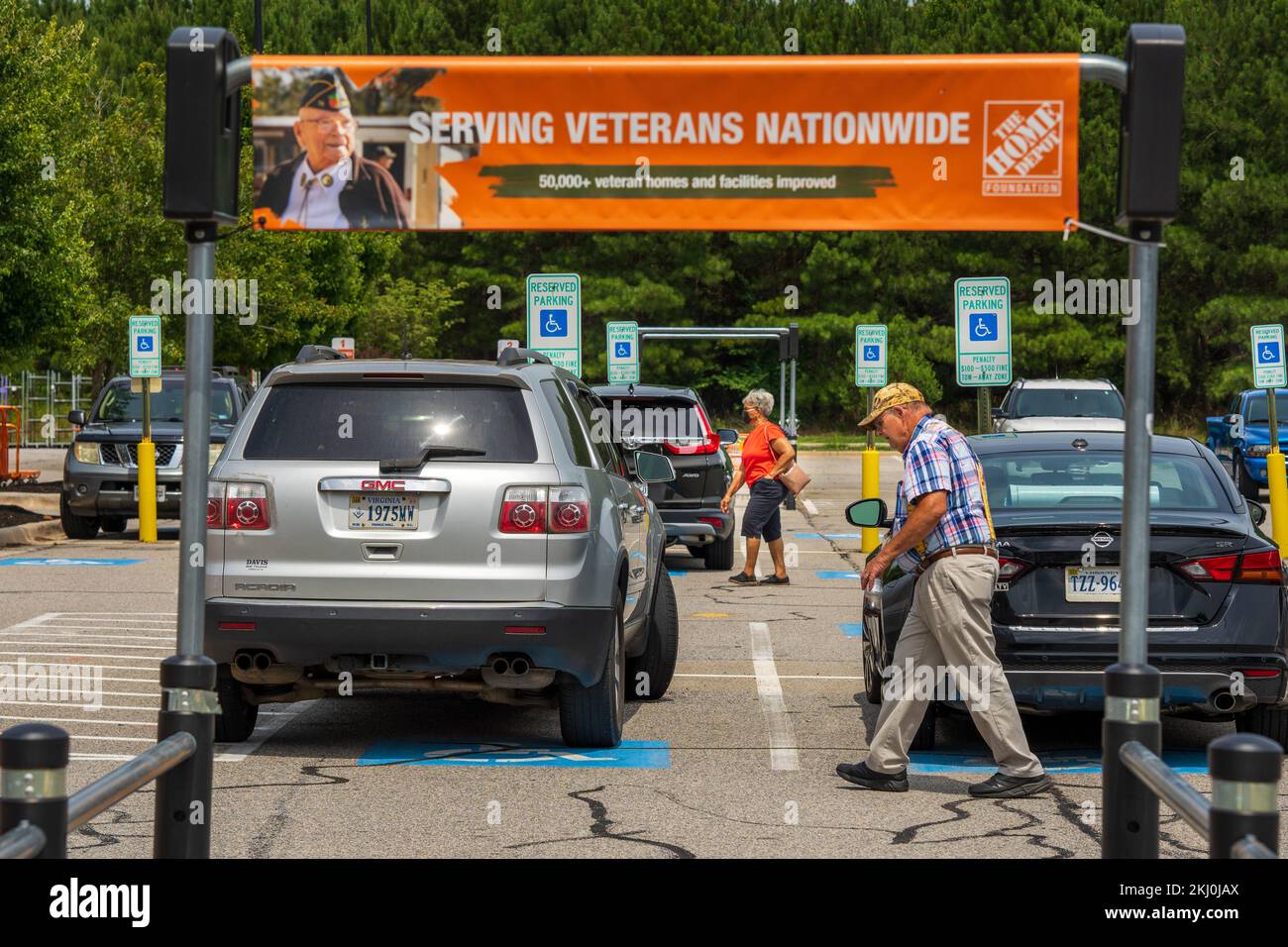 Veterans sign in parking lot of hardware store with elderly man passing ...