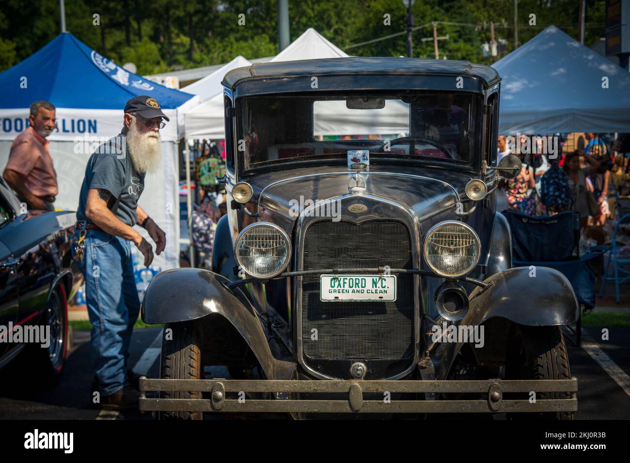 old man with one of the first ford cars at the fair Stock Photo - Alamy