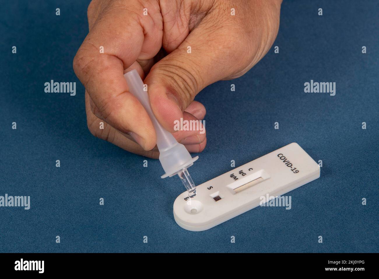 Covid-19 rapid test hand dripping the drop Stock Photo - Alamy