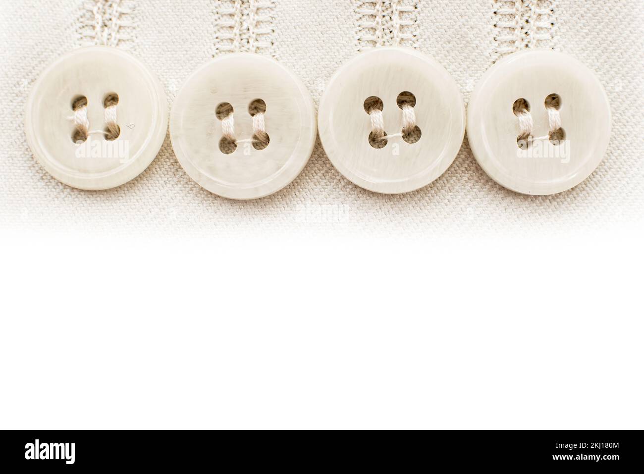 Buttons on the sleeve of a man's jacket on a white background with ...