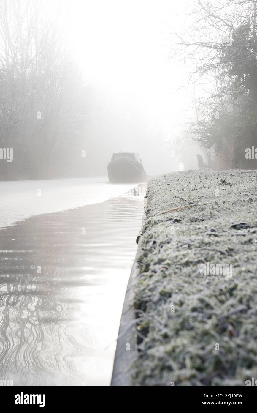 Low POV frosty misty and frozen canal with a canal boat Stock Photo - Alamy
