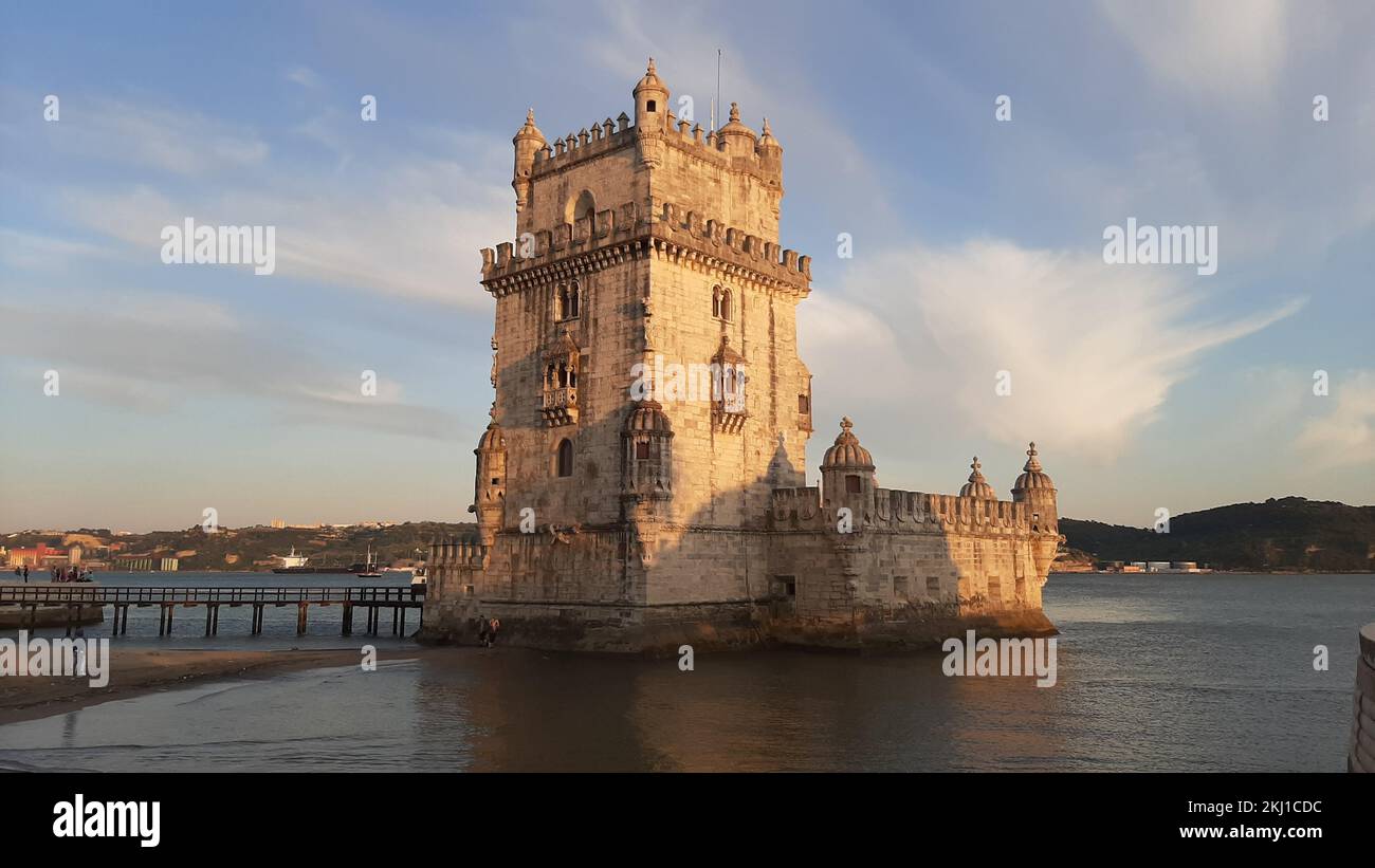 The Belem tower with a cloudy blue sky background in Portugal Stock ...