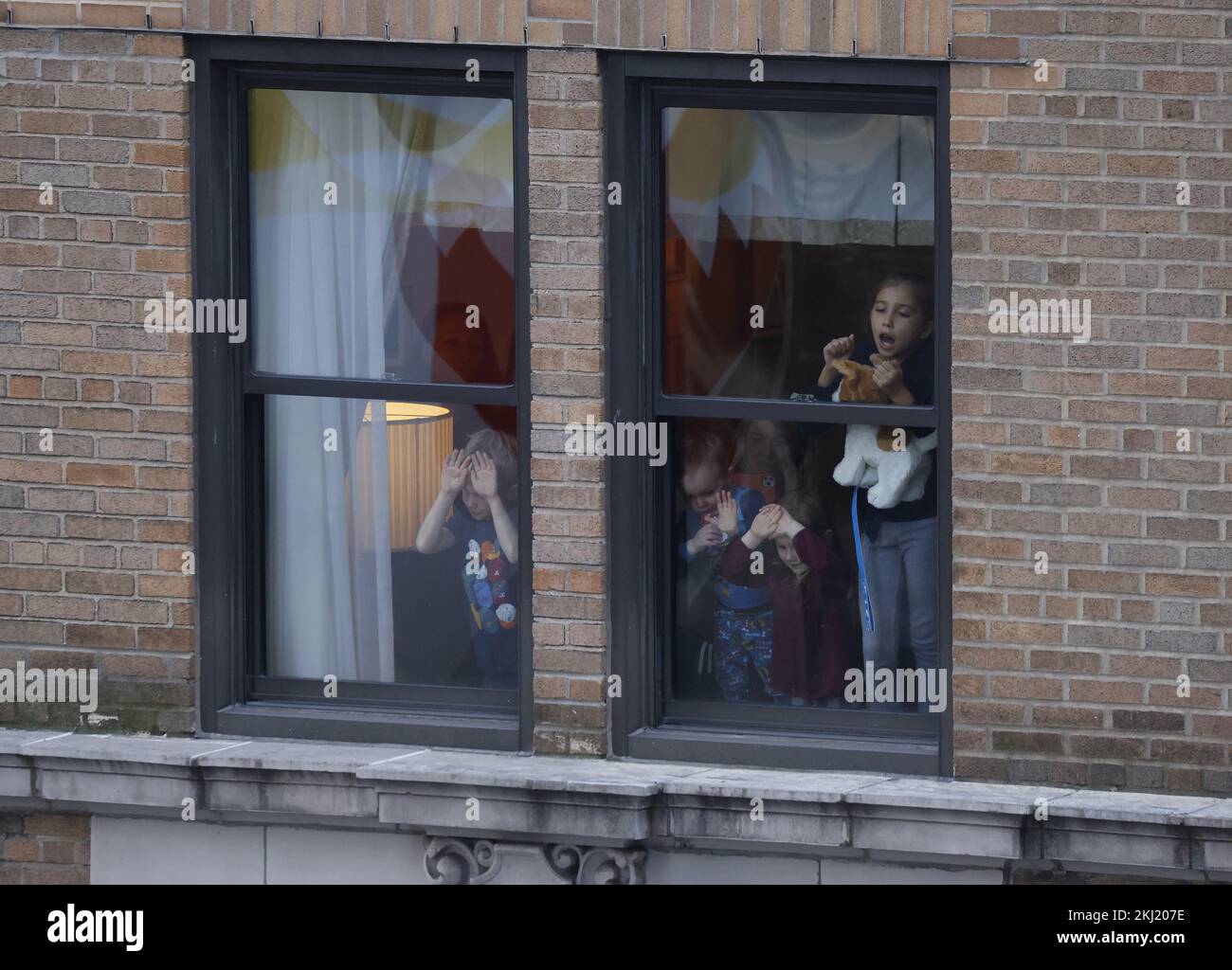 New York, United States. 24th Nov, 2022. Children watch from windows as ...