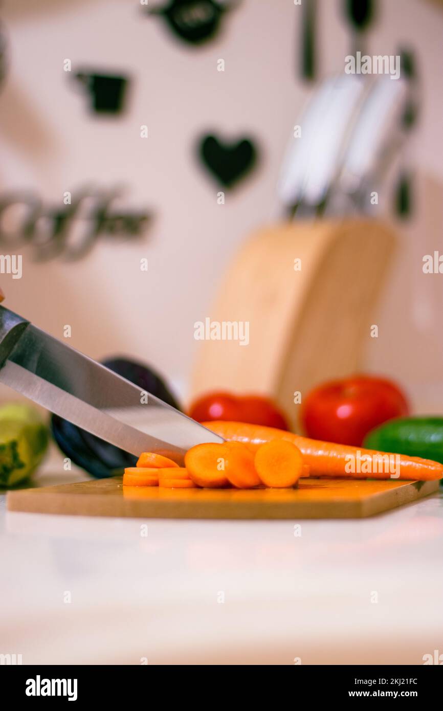 Hand cutting vegetables for soup on kitchen table, close-up.selective ...