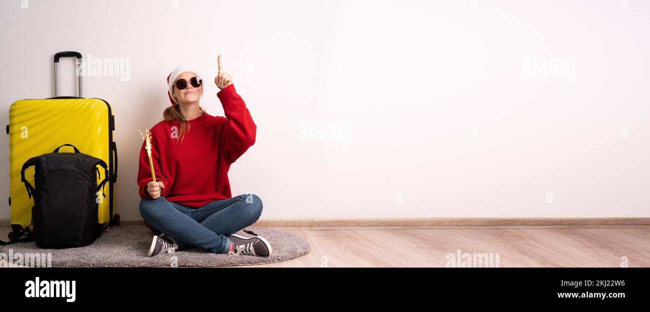 Happy woman santa traveler with suitcase on white background. Christmas ...