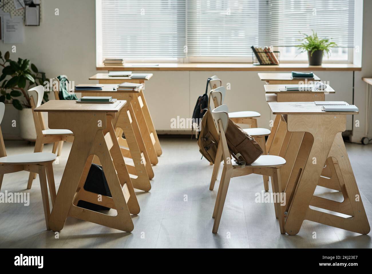 Empty classroom with workplaces of students with books on them ...