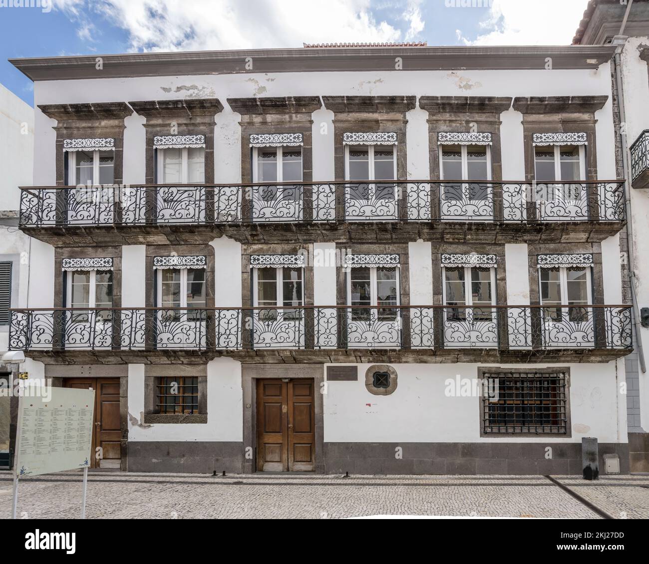 cityscape with traditional black and white facade of old building in town street, shot in bright ...