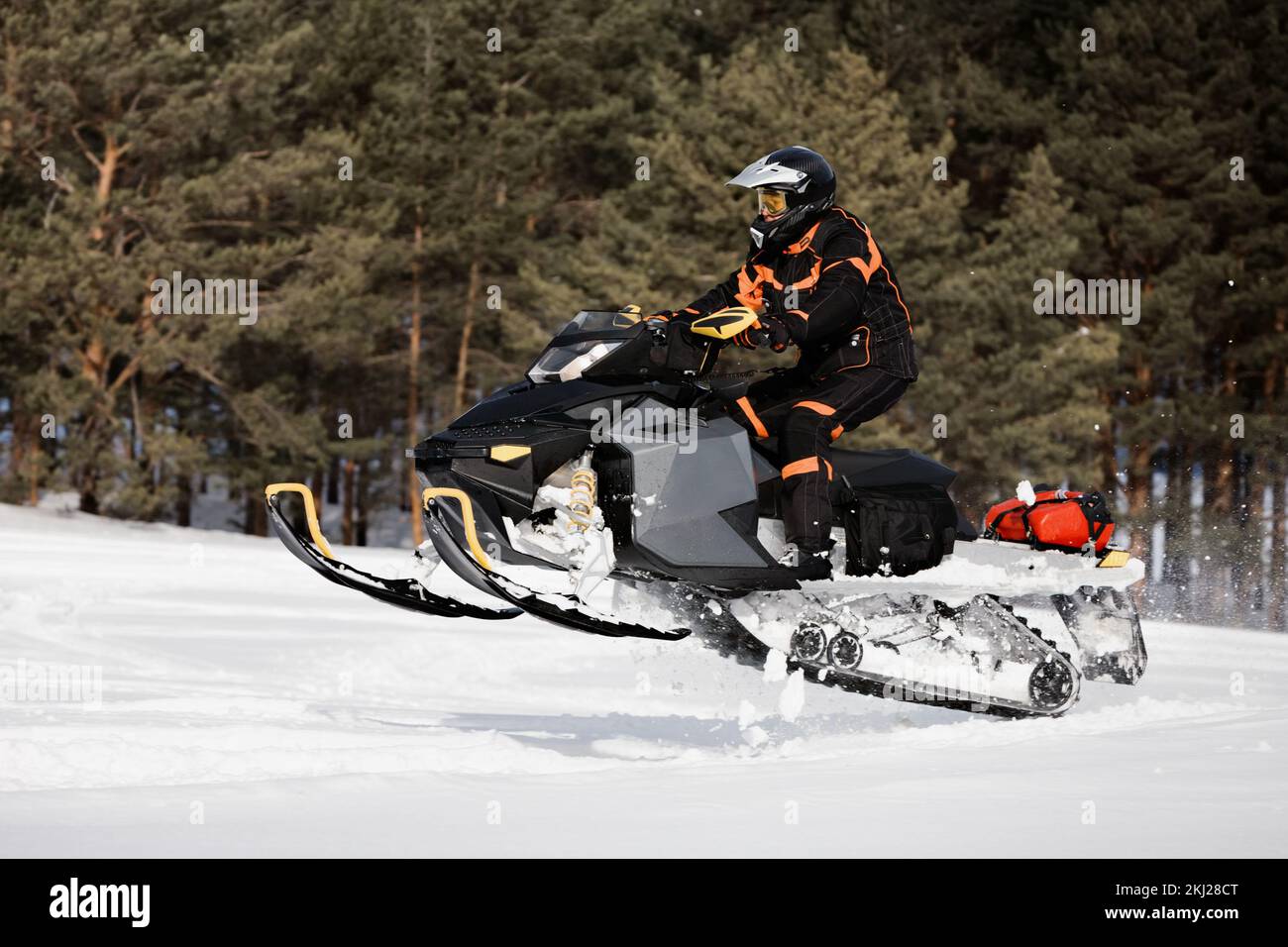 Snowmobile rider driving fast. Riding with fun in white snow powder ...