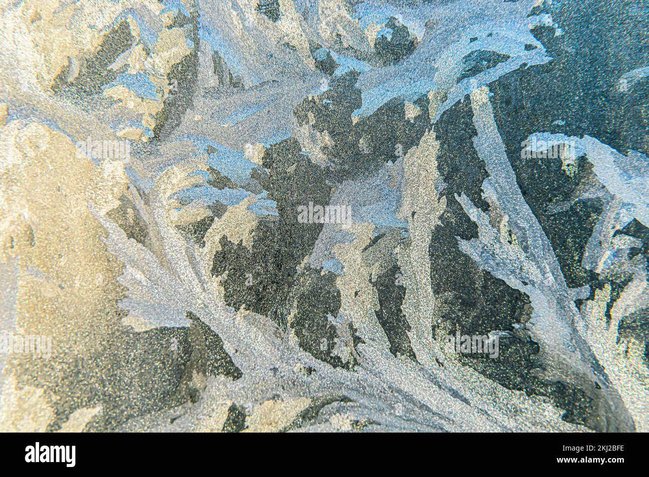 Frozen winter window with shiny ice frost pattern texture. Christmas ...