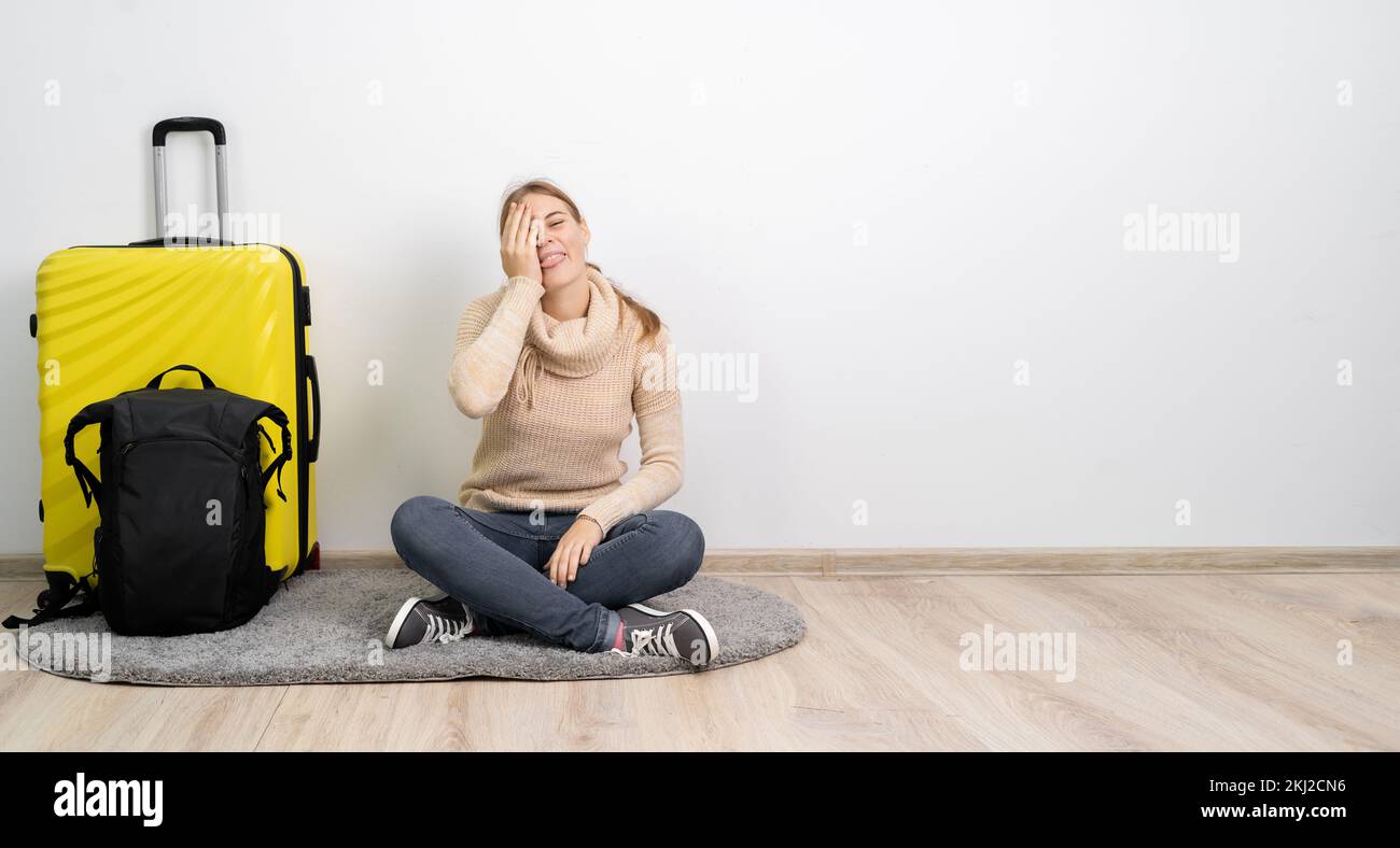 Woman traveler with suitcase in sweater ready to go to travel have hand ...