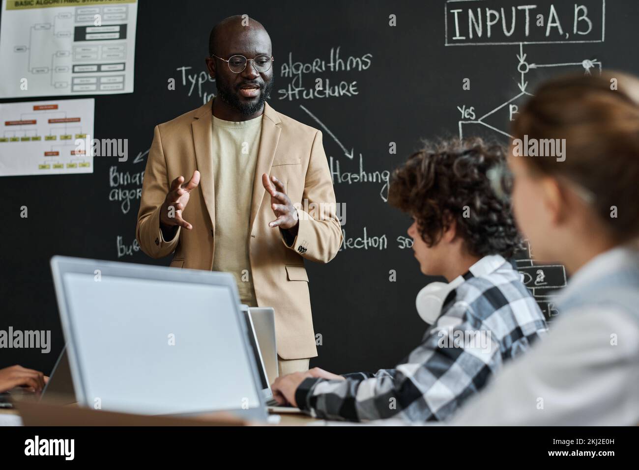 African American teacher explaining the work of computer system to ...