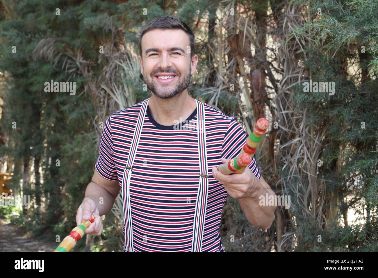 Cute male juggler practicing outdoors Stock Photo - Alamy