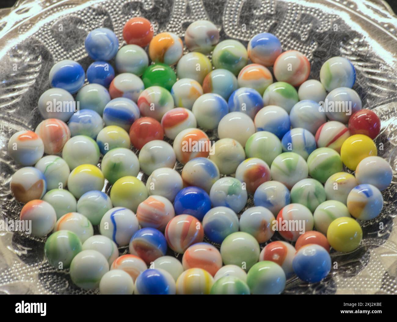 A plateful of non-translucent yet colourful, vintage marbles with ...