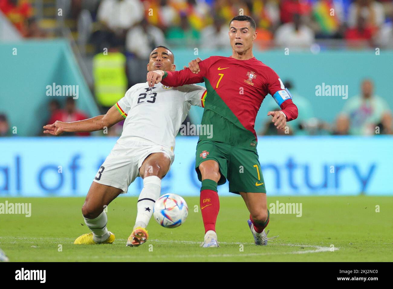Doha, Qatar. 24th Nov, 2022. Cristiano Ronaldo of Portugal is challenged by Alexander Djiku of ...