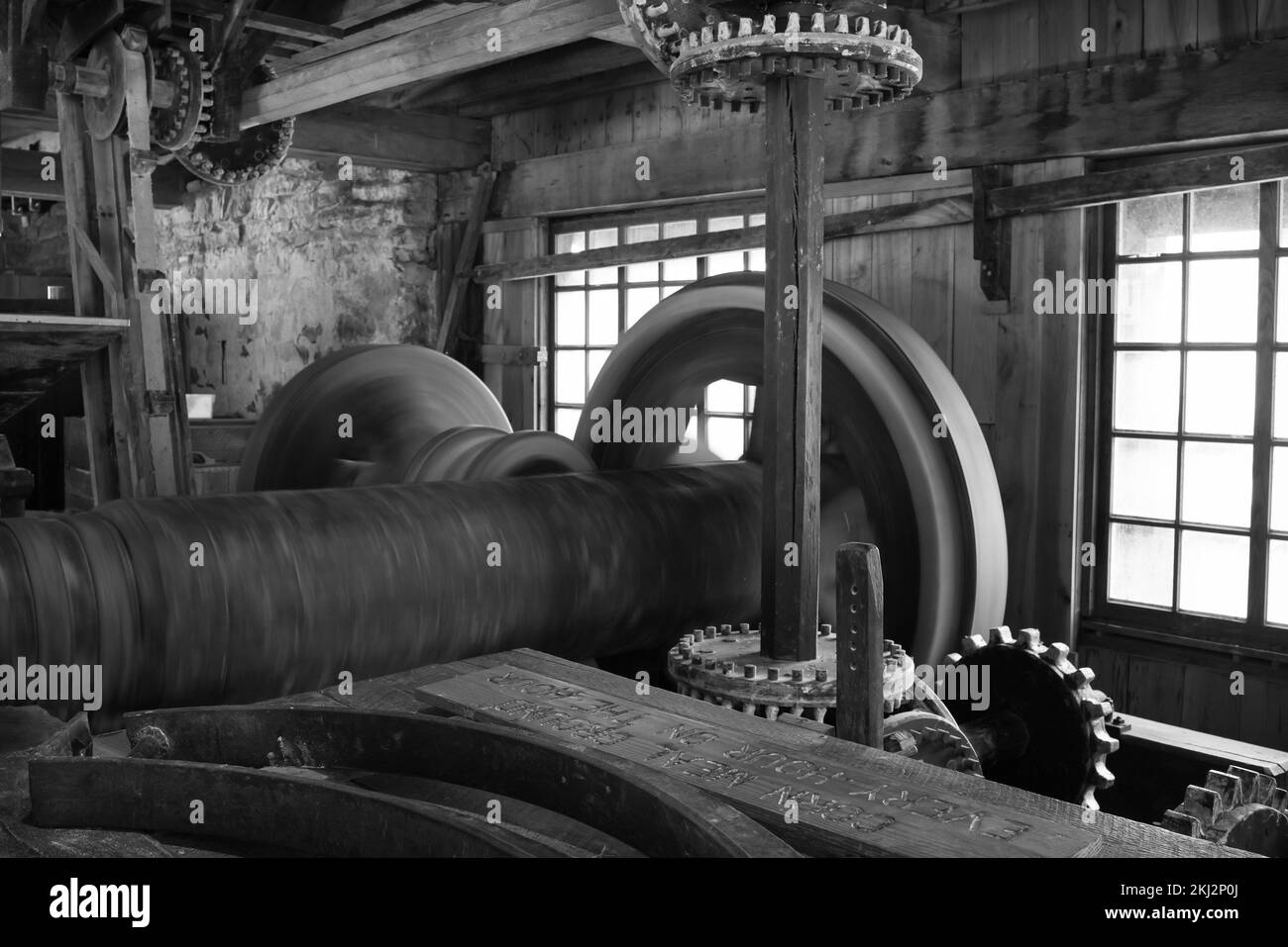 A grayscale of the steam engine inside wall and windows background ...