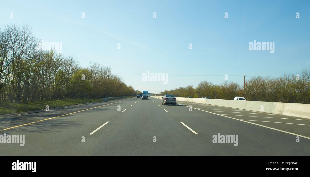Rear view of cars driving on motorway, Ireland. Road with metal safety ...