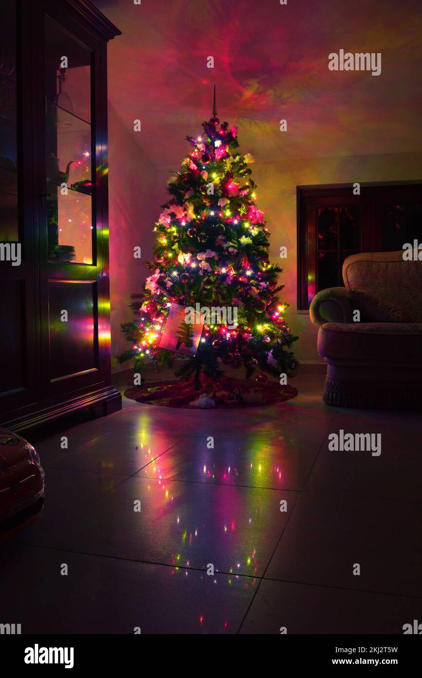 Postcard with a Christmas tree in a window with colored lights.Postcard ...