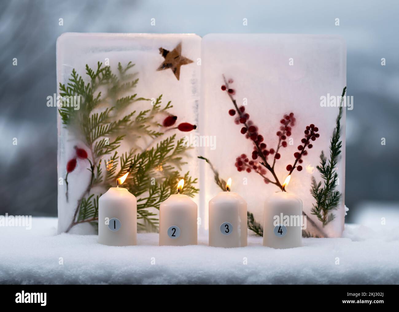 Christmas, advent wreath with four white burning candles decorated with ...