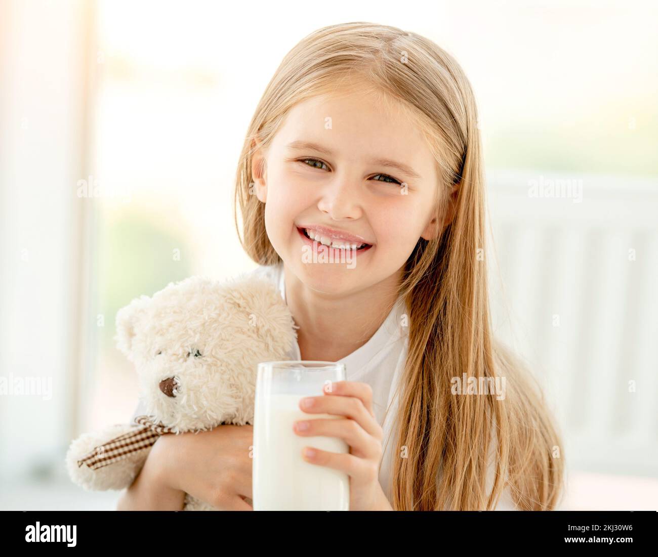 Cute child girl cuddling with teddy bear Stock Photo - Alamy