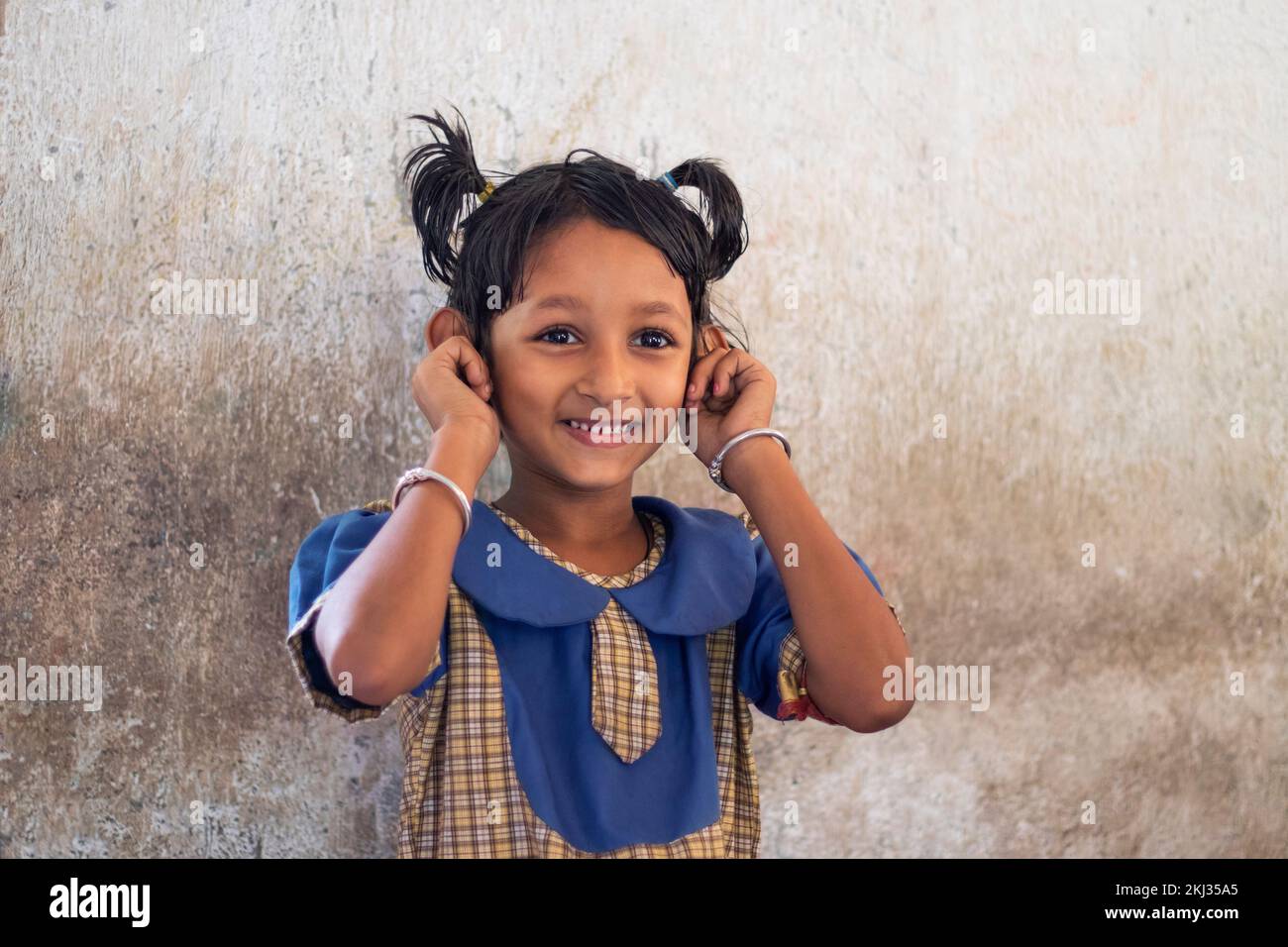 school girl holding onto his ears in classroom Stock Photo - Alamy