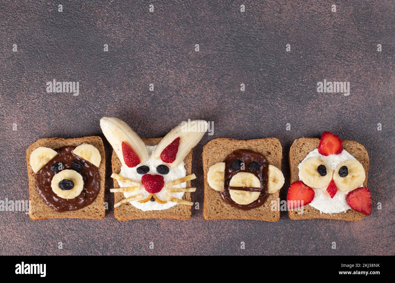 Four sweet toasts for kids in shape of chick, bear, rabbit and monkey ...