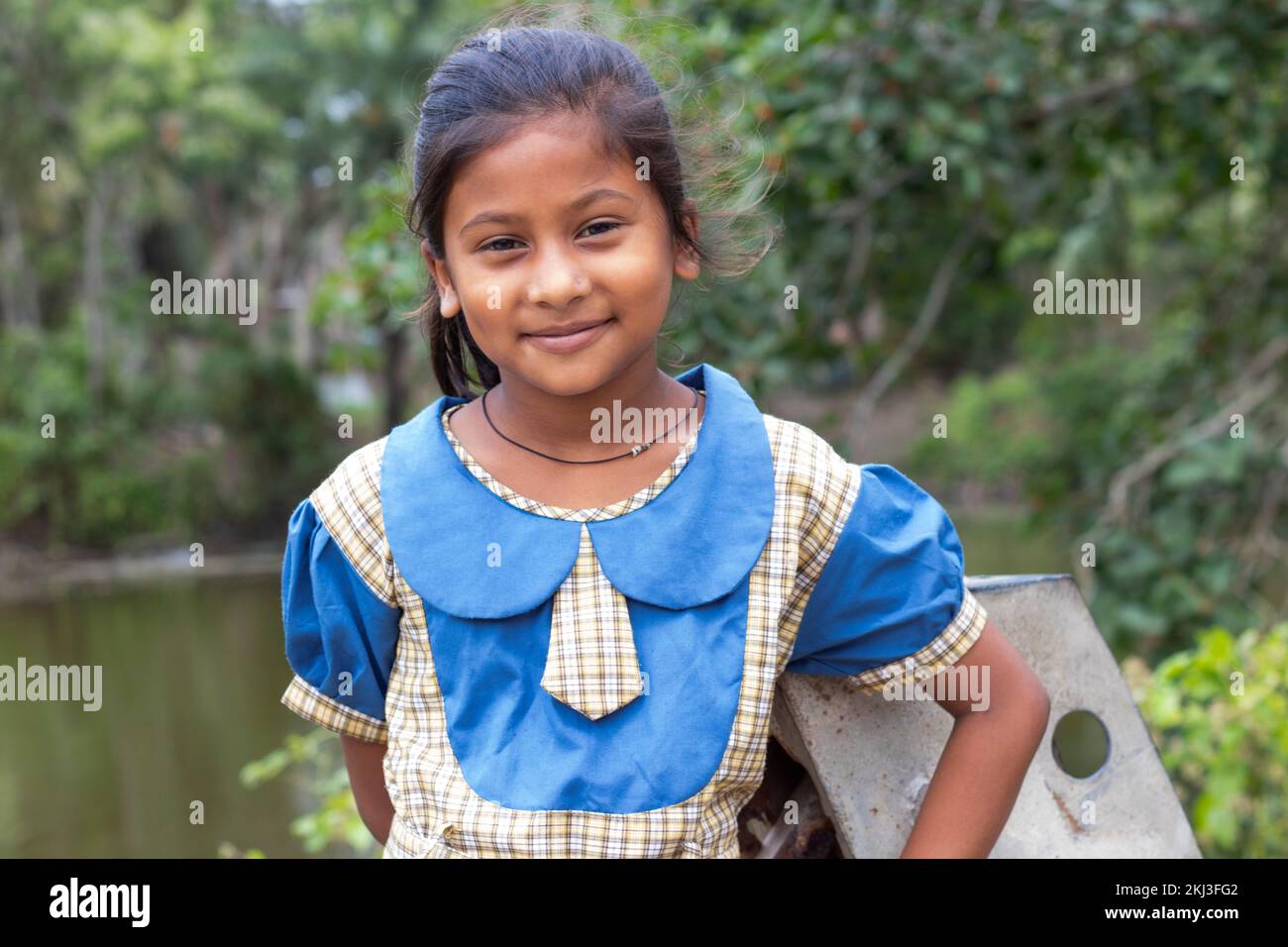 Smiling school girl standing outdoor Stock Photo - Alamy