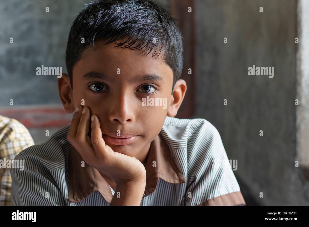 school boy sitting in his class and looking at camera Stock Photo - Alamy