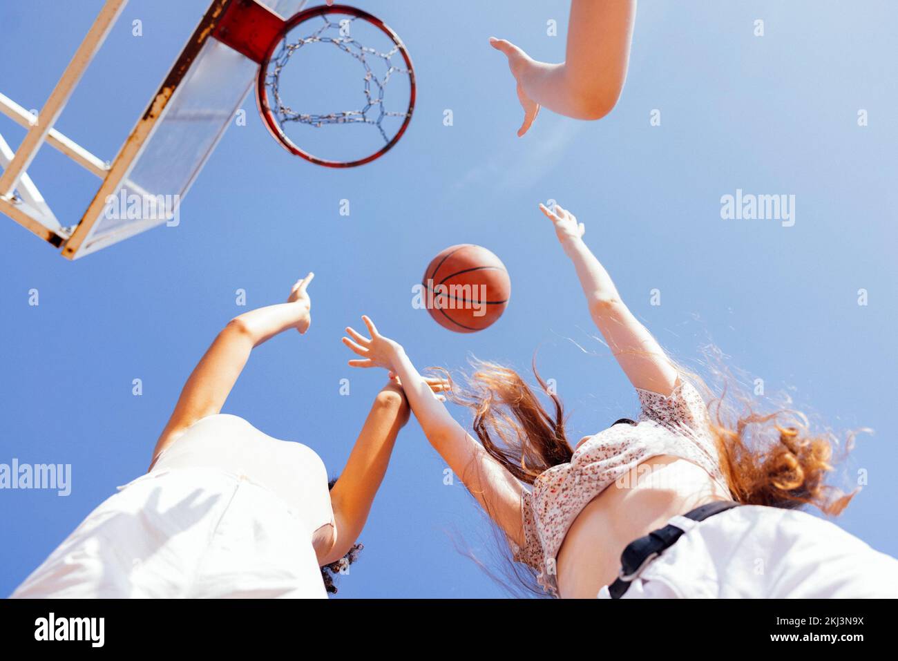 Multicultural group of young female friends bonding outdoors and having ...