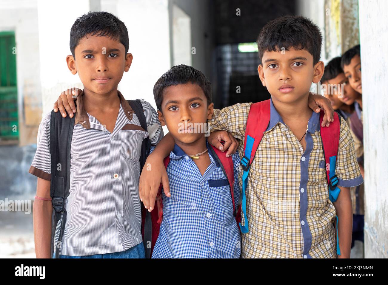 Three school friends with backpack at school Stock Photo - Alamy