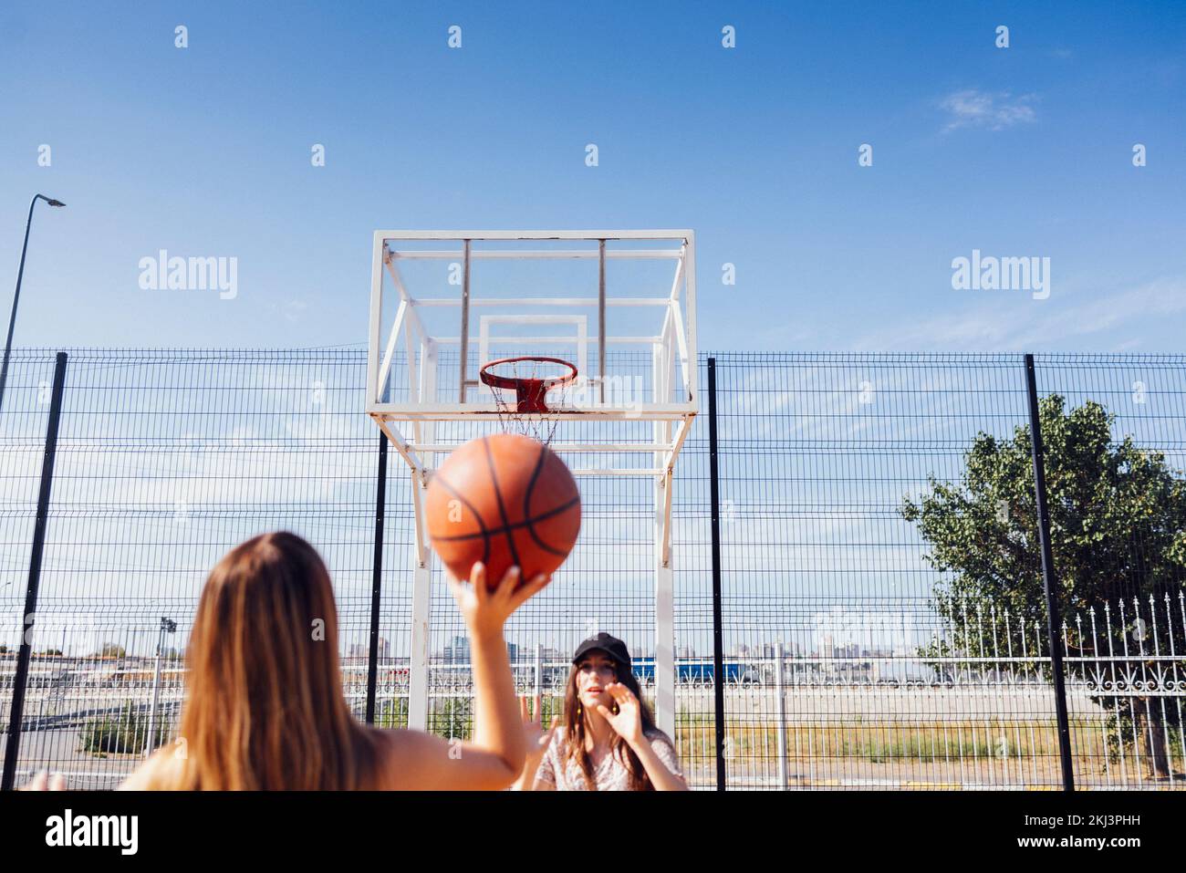 Multicultural group of young female friends bonding outdoors and having ...