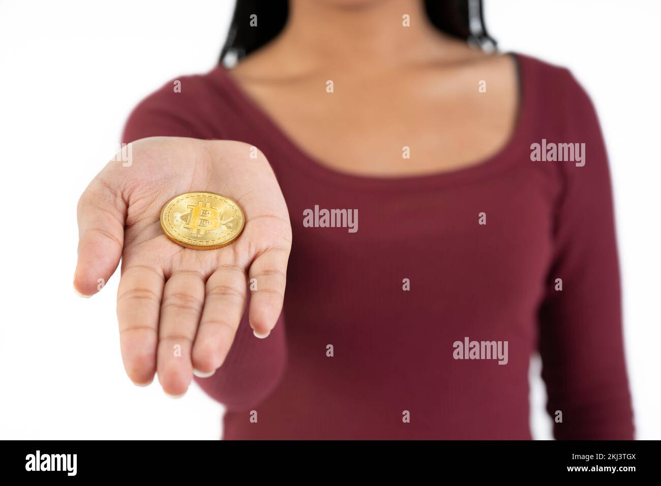 Young black woman showing a bitcoin coin to the camera on a white ...