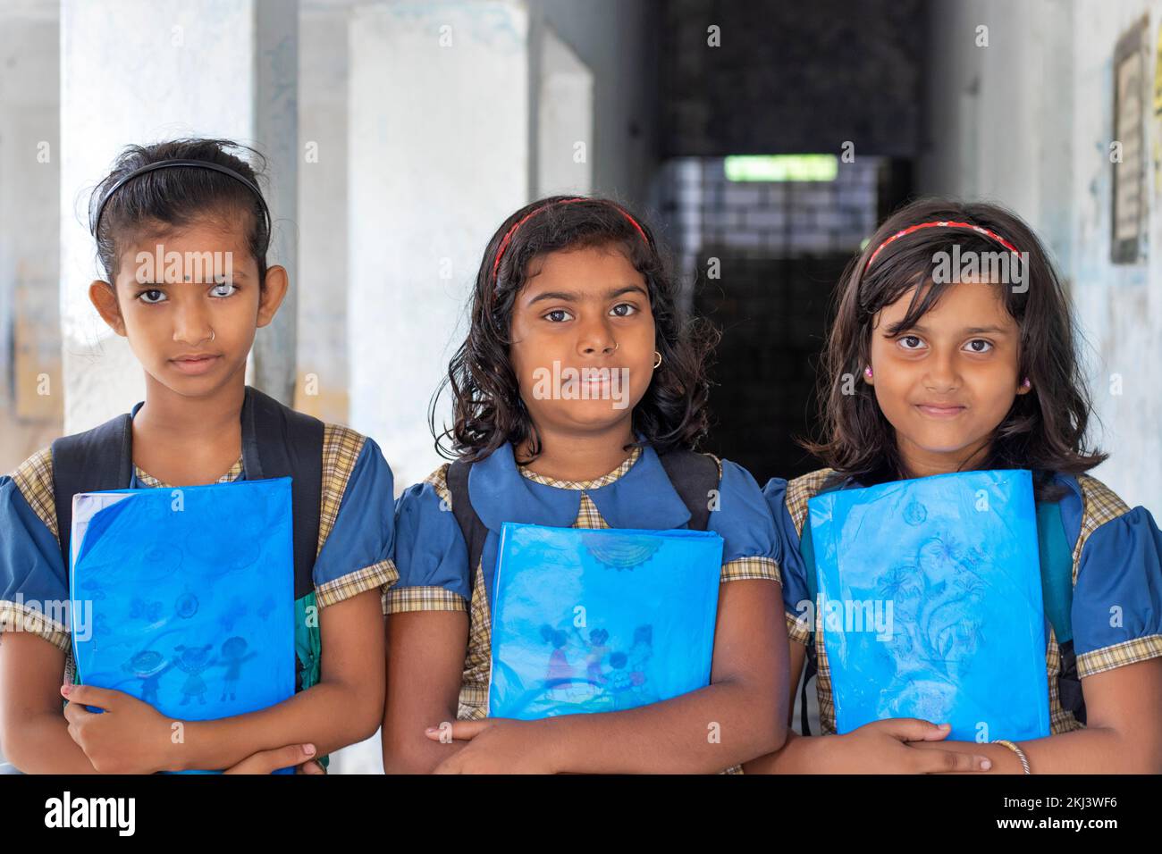 School Children's holding books standing at school Stock Photo - Alamy