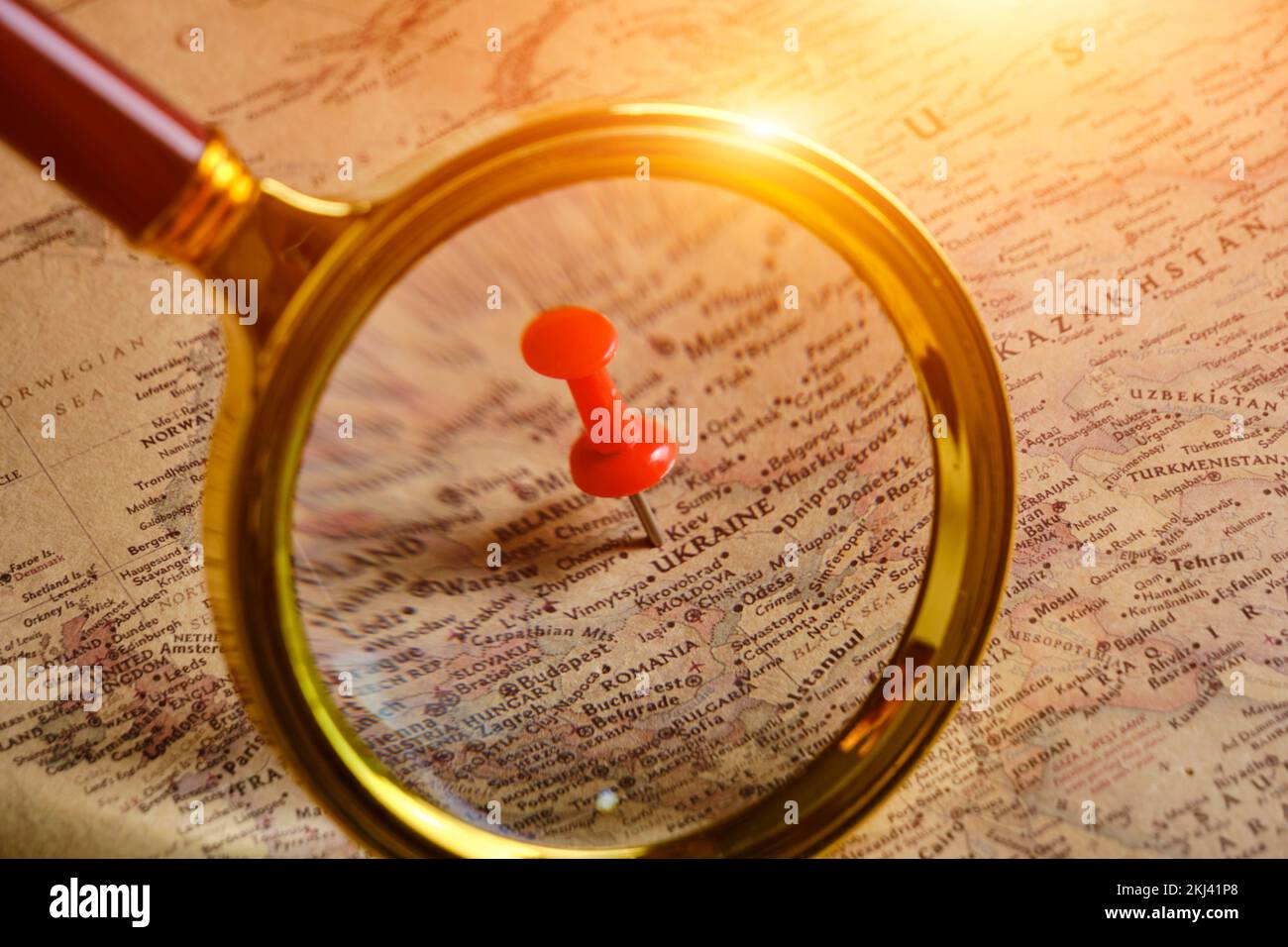 Magnifying glass with glare sun and red button on map pointing to ...