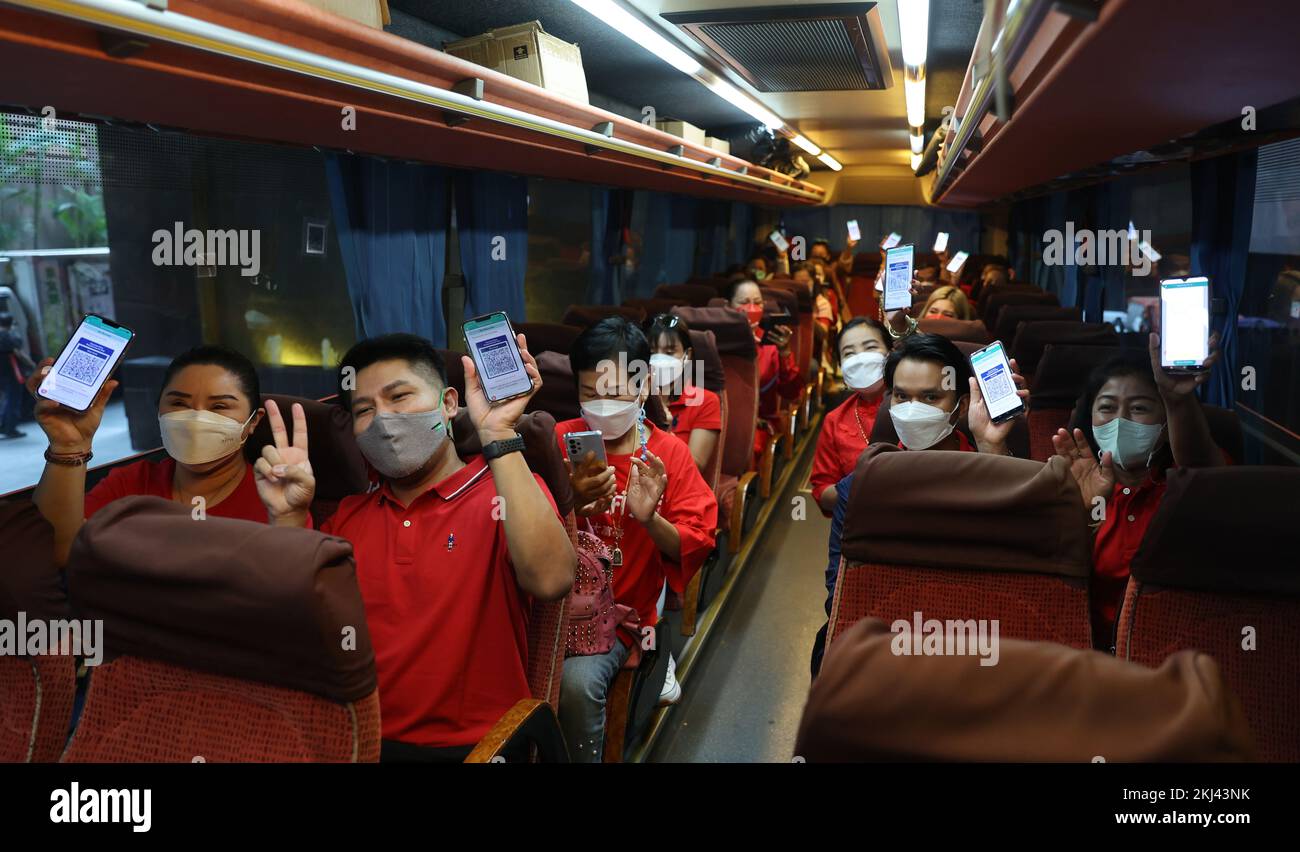 Members of a tour group from Thailand show off their blue codes which they got on the last day ...