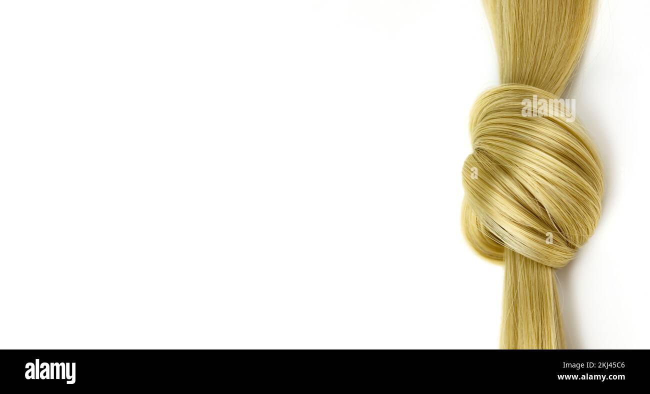 Blonde hair lock tied in knot. Lock of blonde wavy hair on white ...