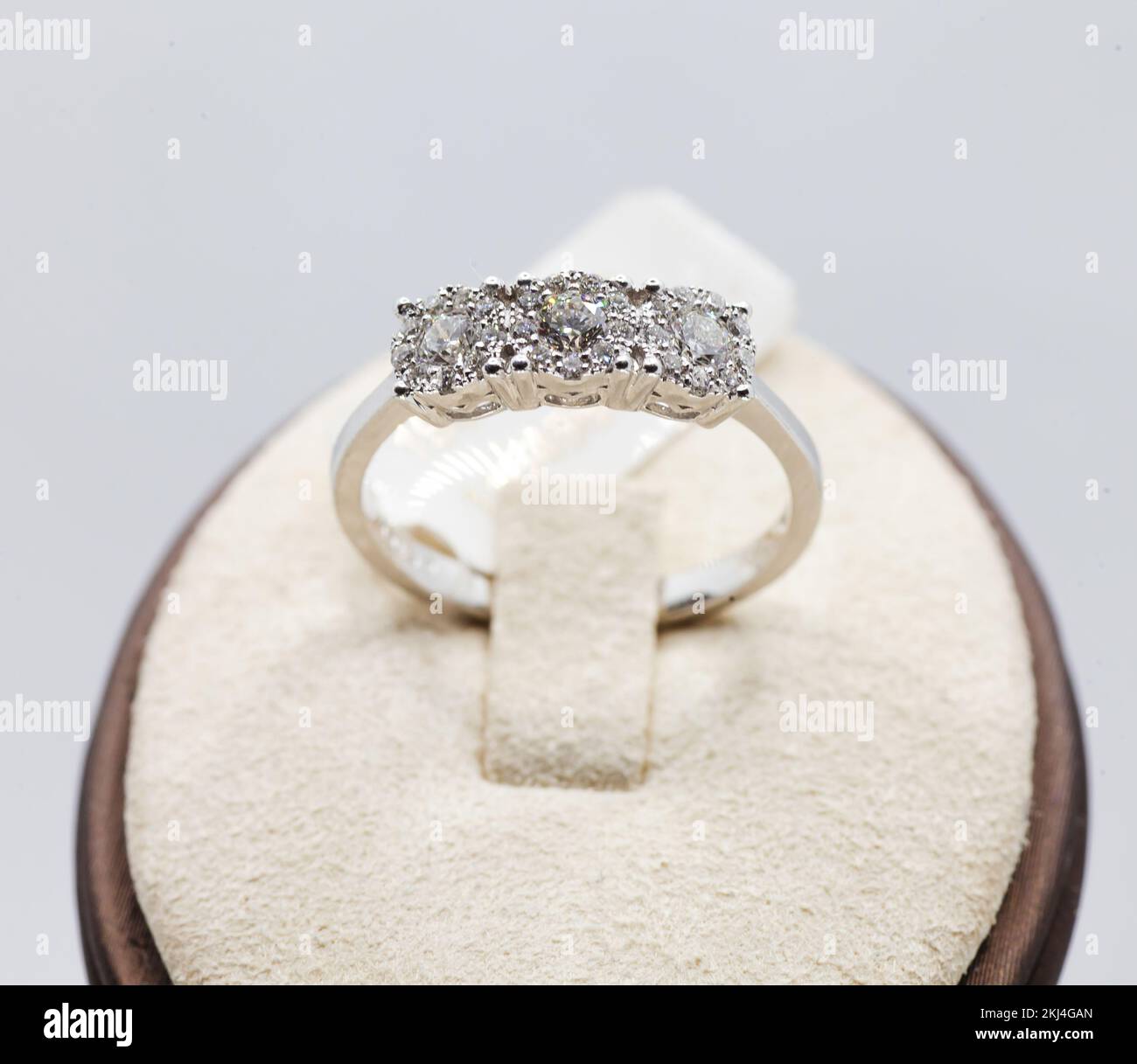 Engagement diamond ring on a mirror surface. emeralds, sapphires, and ...