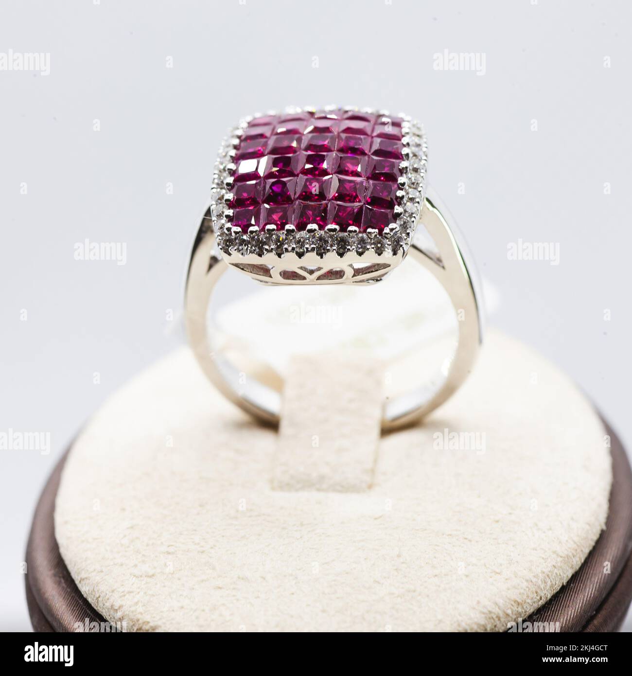 Engagement diamond ring on a mirror surface. emeralds, sapphires, and ...