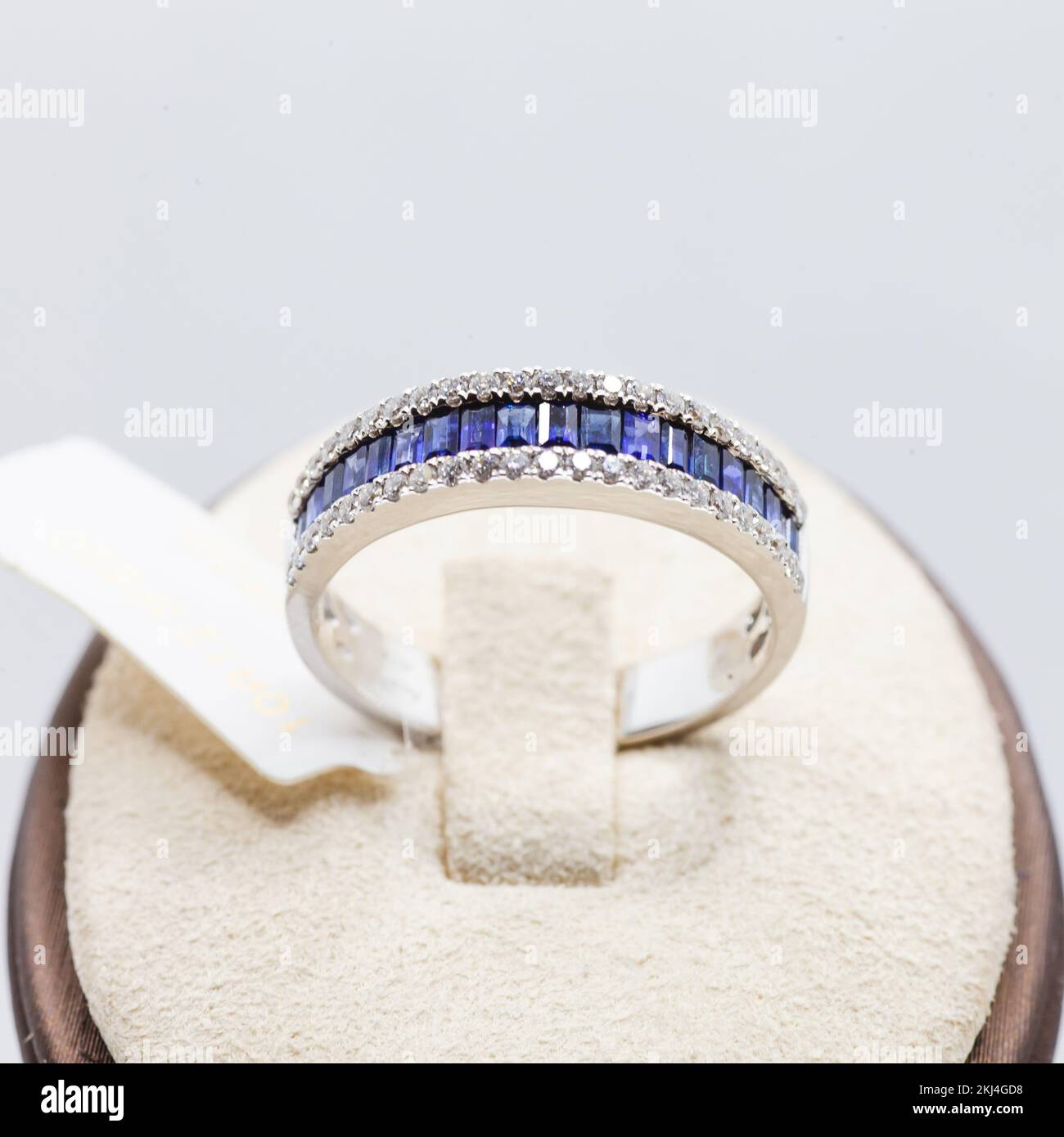 Engagement diamond ring on a mirror surface. emeralds, sapphires, and ...