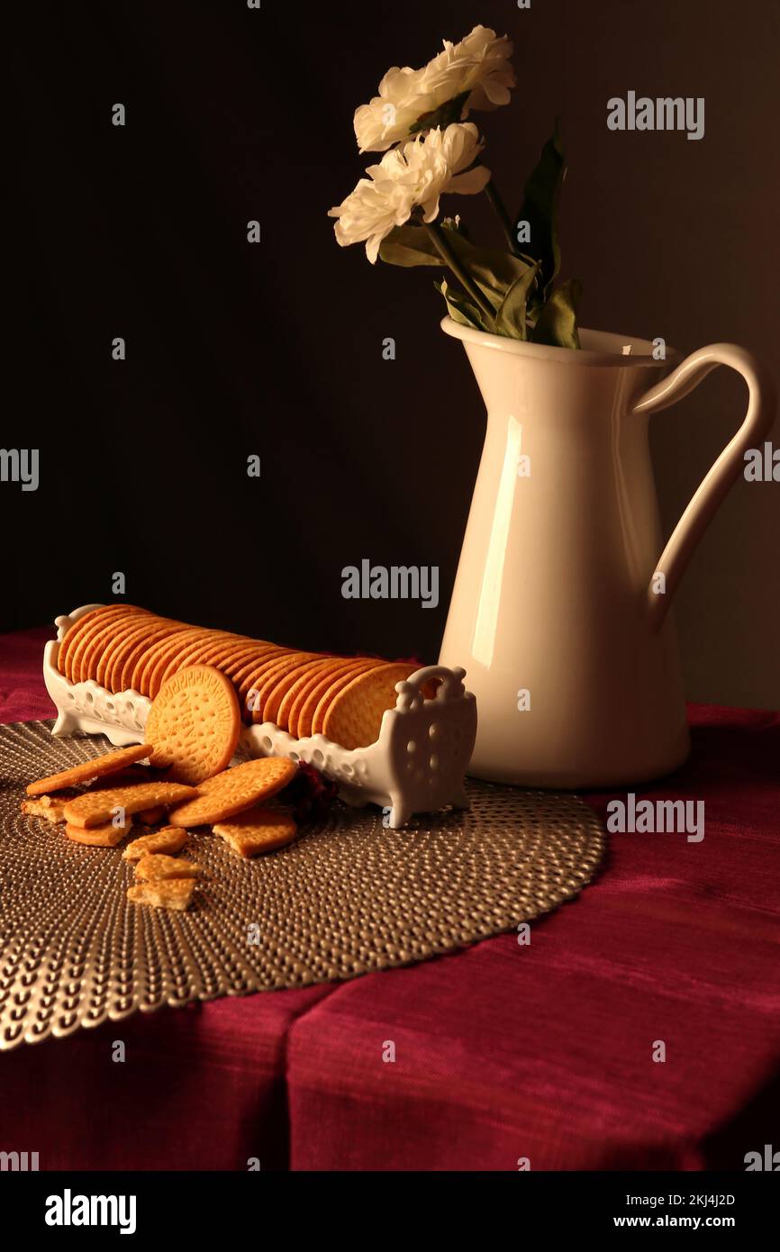 A vertical still life of a ceramic vase and cookies Stock Photo - Alamy