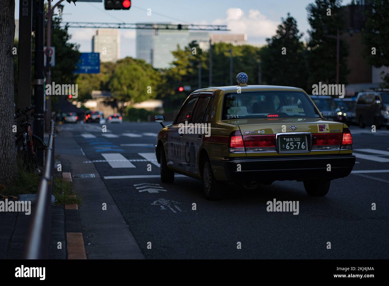 A Japanese Taxi driving on the street in Tokyo, Japan Stock Photo - Alamy