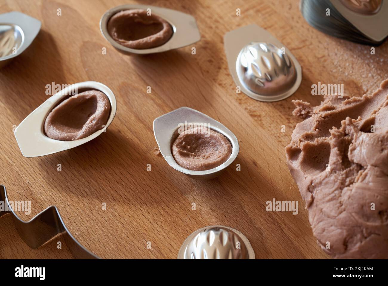 Preparation of nut shaped Christmas cookies using tin molds Stock Photo ...