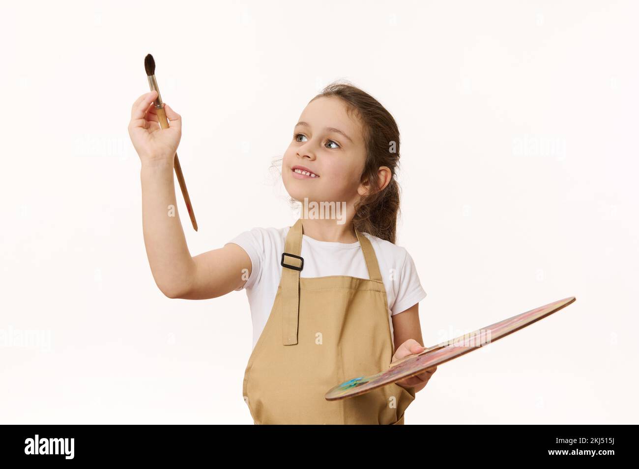 Portrait on white background of preschooler child, cute baby girl holds ...