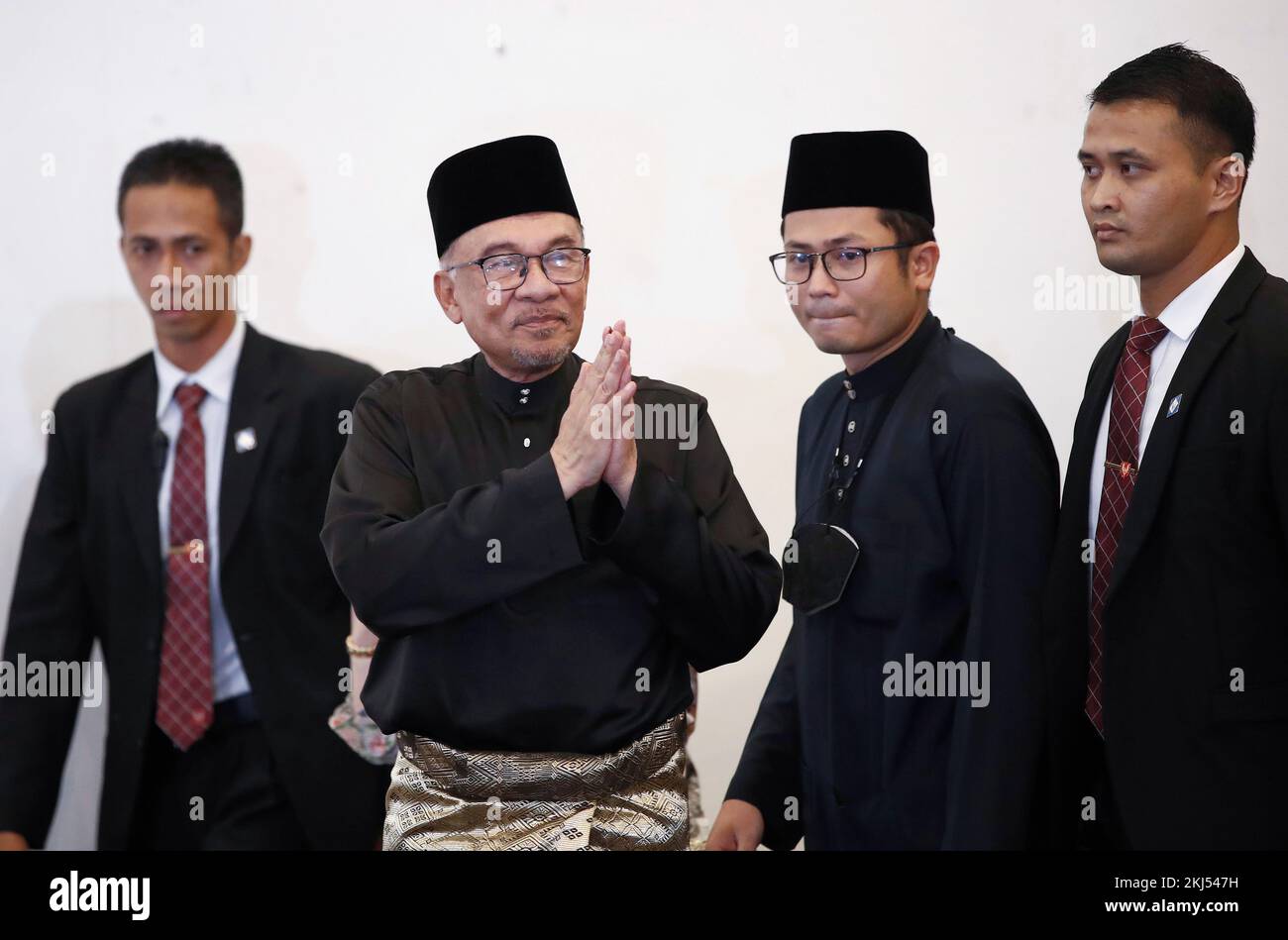 Malaysia's newly appointed Prime Minister Anwar Ibrahim (L) arrives at ...