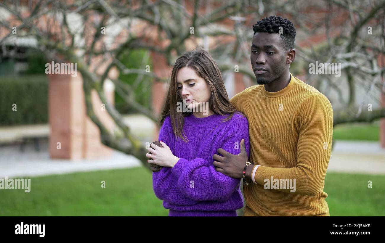 Boyfriend consoling depressed girlfriend. Partner calming girl walking ...