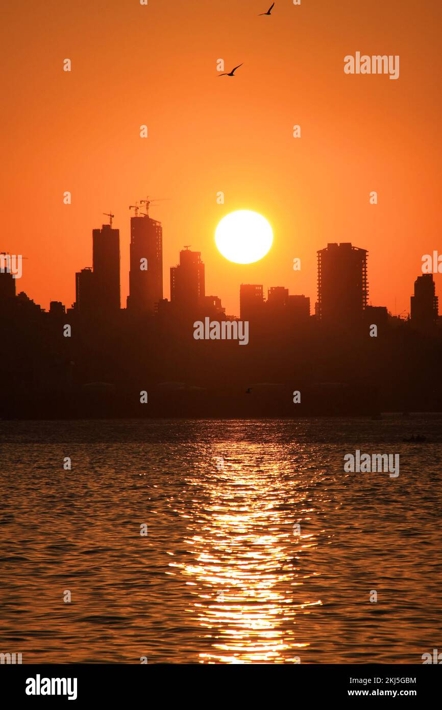 The setting sun between the buildings of Beirut, Lebanon Stock Photo ...
